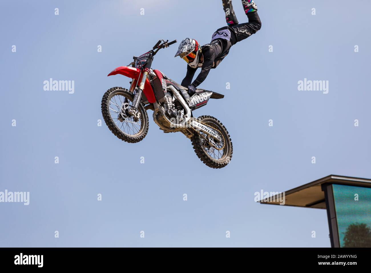 Motorcycle rider doing a handstand on the bike during a demonstration ...