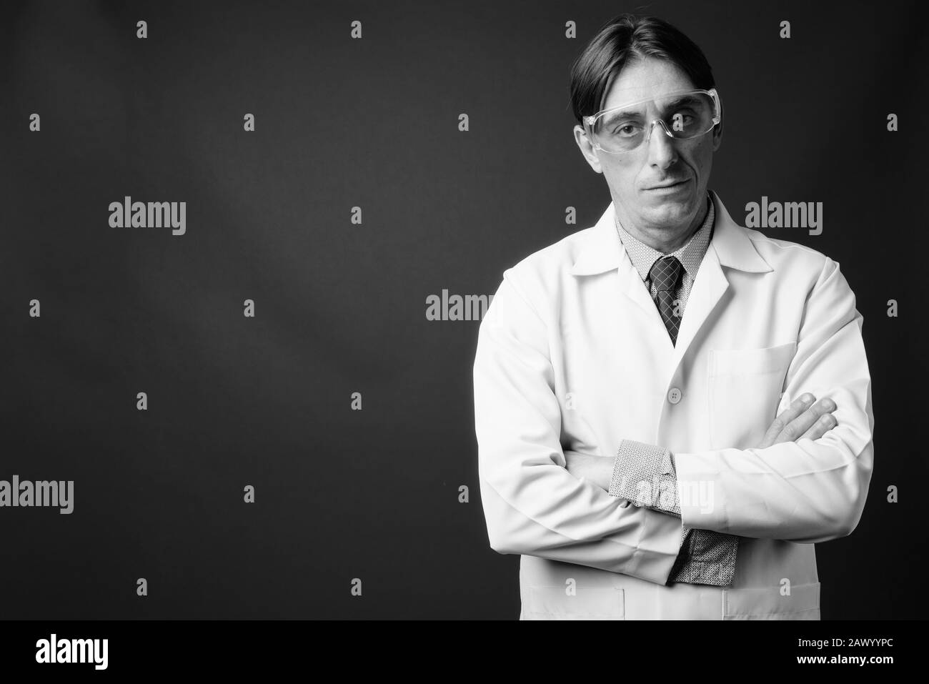 Mature handsome Italian man doctor wearing protective glasses Stock ...
