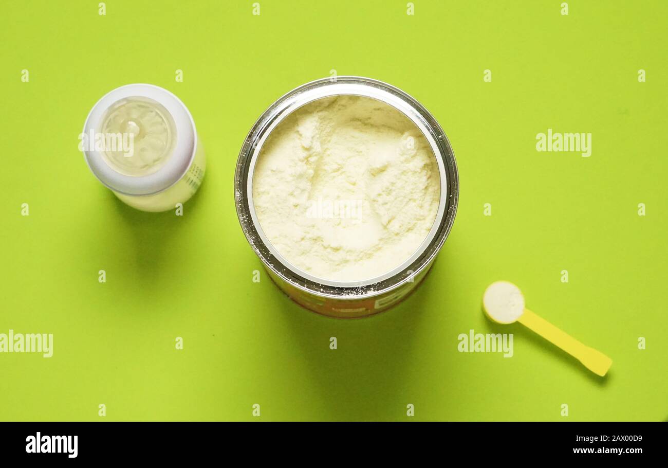 High angle shot of a baby bottle and milk with a yellow-green color in ...