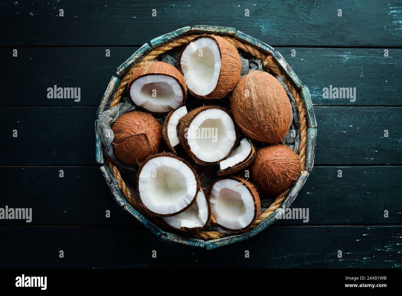 Coconut in a wooden box. Tropical Fruits. Nut. Top view. Free space for ...