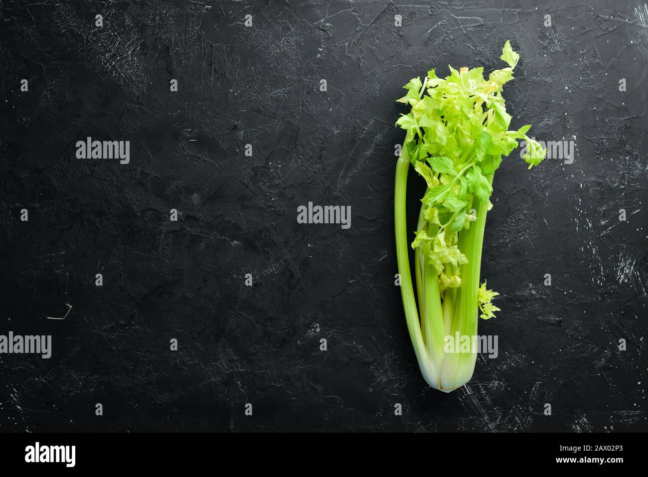 Fresh green celery stalk on a black background. Healthy food. Top view ...