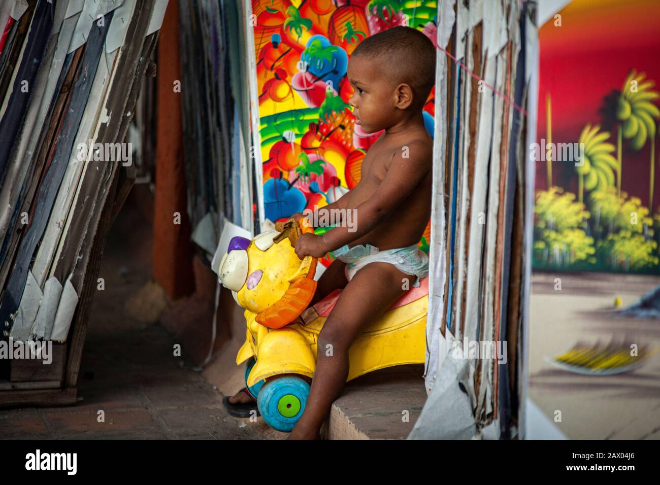 Dominican child plays in the streets of Dominicus Stock Photo - Alamy
