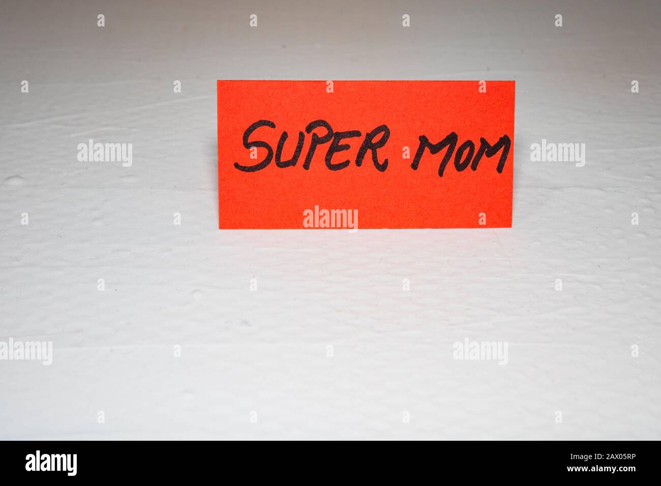 Super mom writing love text for mother on paper. Label tag with lovely ...