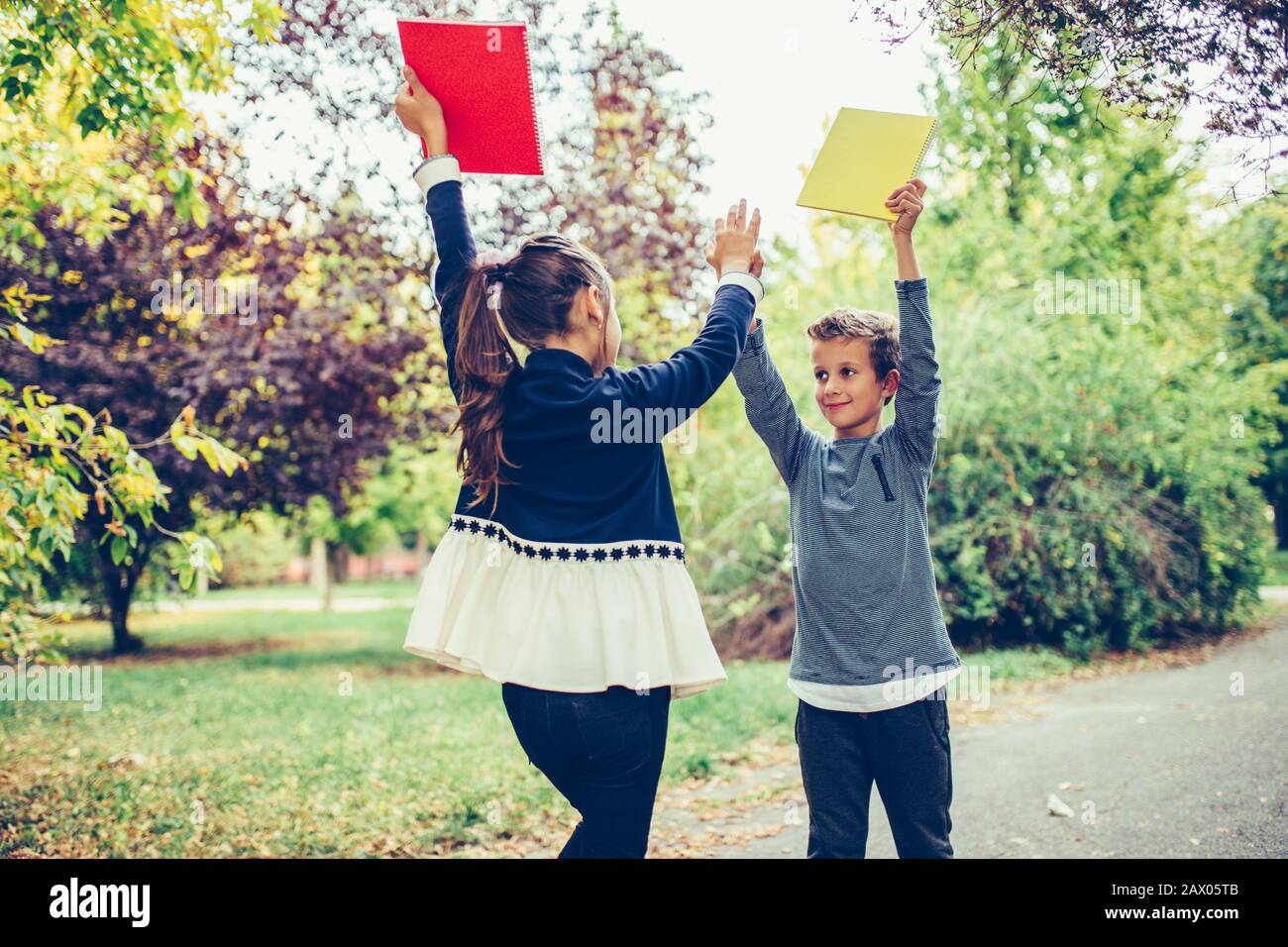 Happy little children celebrating success while giving high five . Two ...