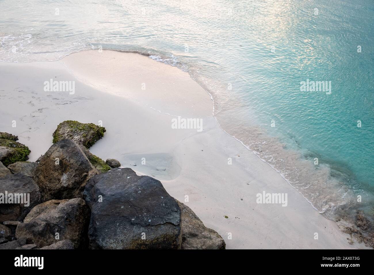Clean sandy beach with clear blue sea-good for a background Stock Photo ...