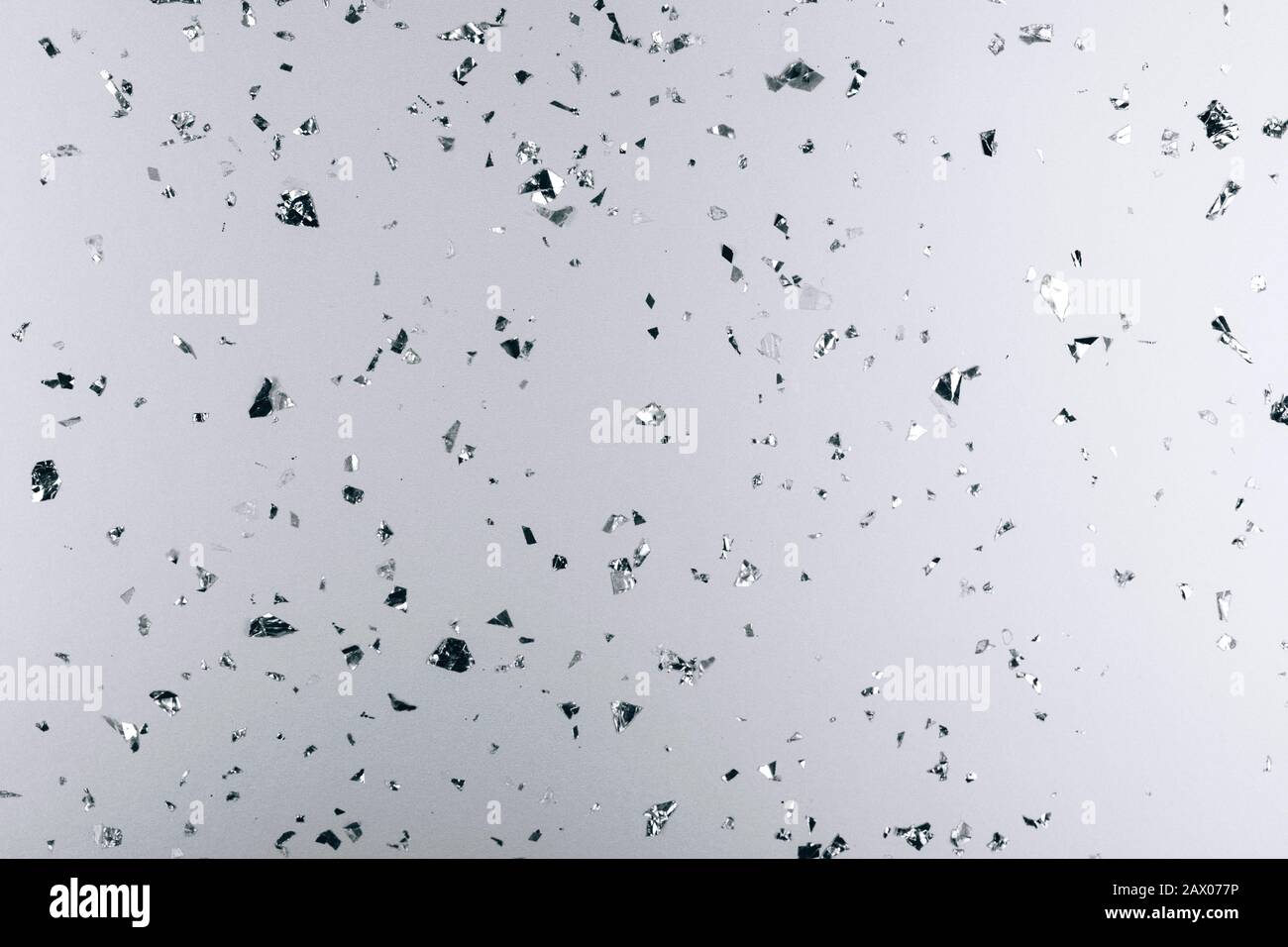 Silver falling confetti on metallic backdrop. Festive and party concept ...