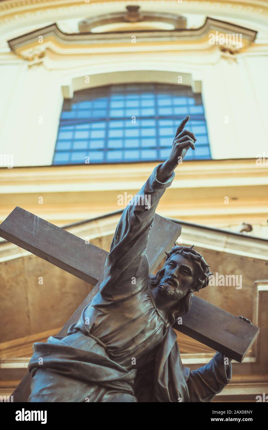 Vertical shot of the statue of Jesus Christ behind a building Stock ...