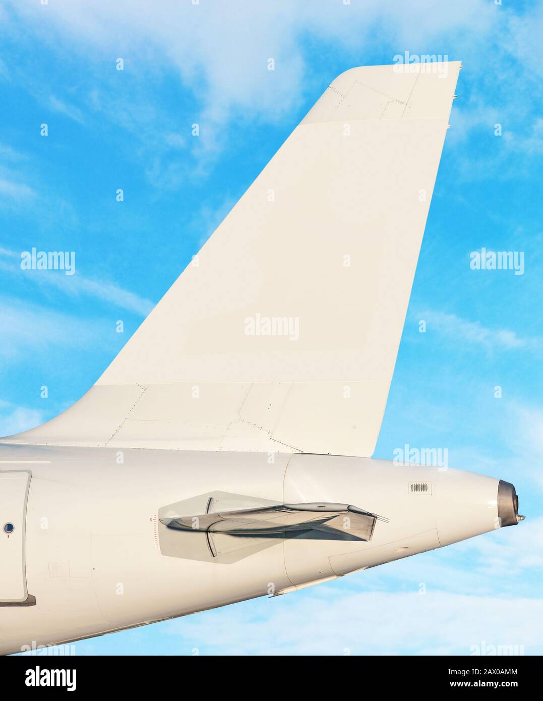 Airplane tail fin - sky with white clouds in background Stock Photo - Alamy