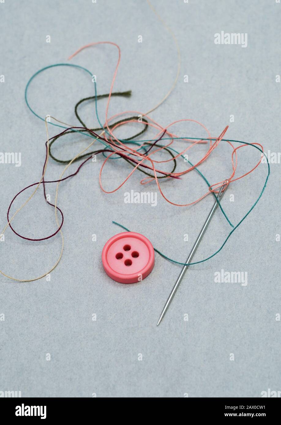 button, needle and different threads Stock Photo - Alamy