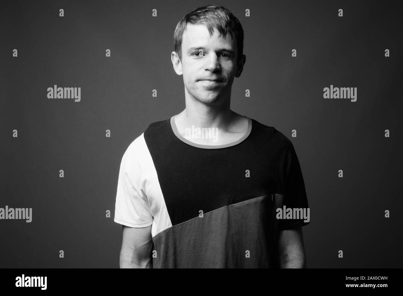 Portrait of man against gray background in black and white Stock Photo ...