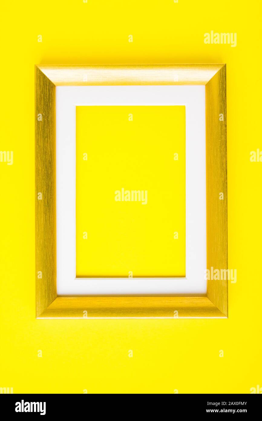 Empty picture frame gold wood frame on yellow background Stock Photo ...
