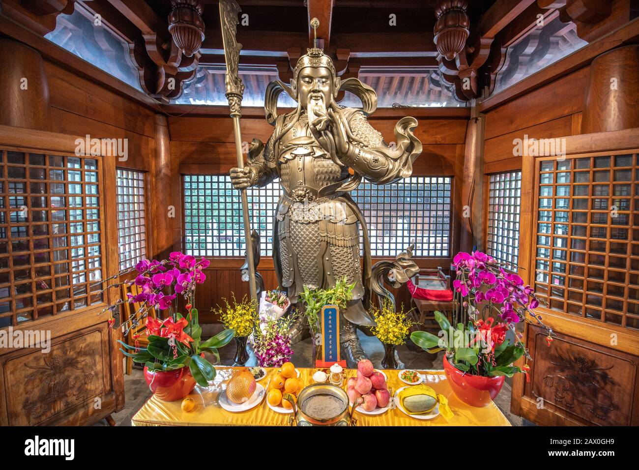 A statue in the Jing'an Temple surrounded by generous offerings ...