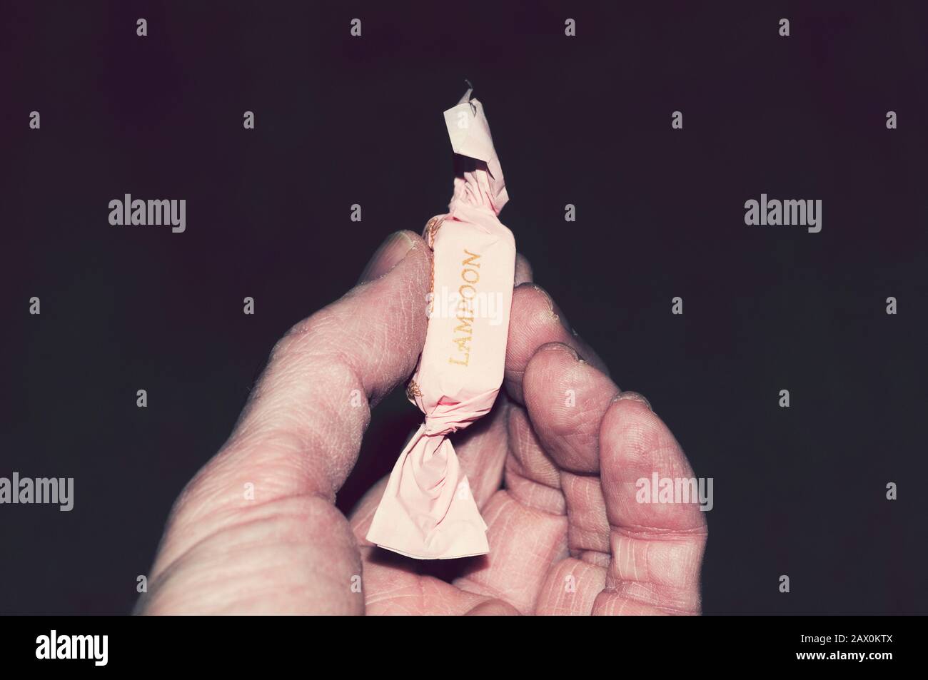 Man's Hand holding candy Stock Photo - Alamy