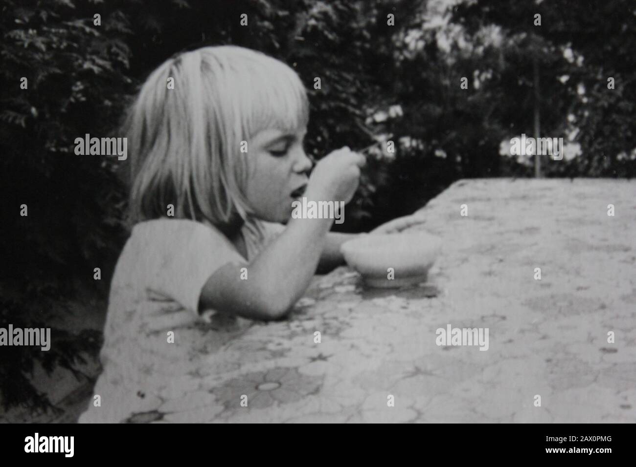 Fine 1970s black and white vintage photography of a kid eating a meal ...