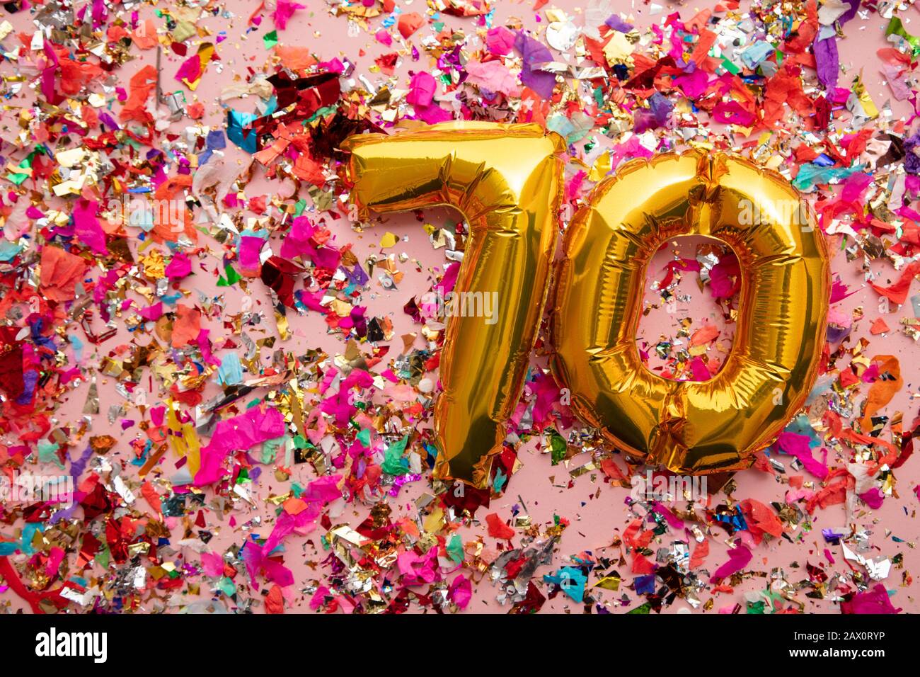 Number 70 gold birthday celebration balloon on a confetti glitter ...
