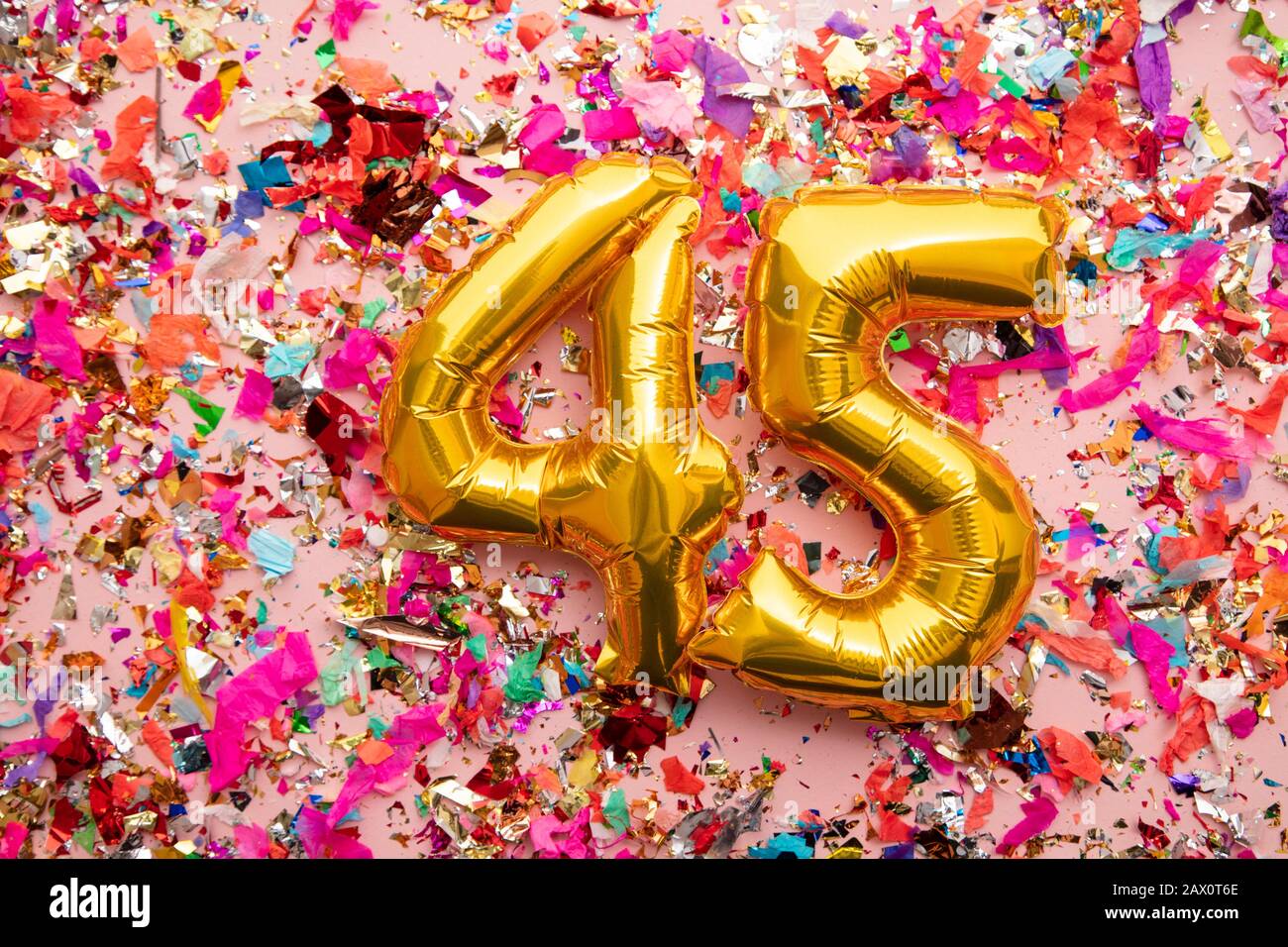 Number 45 gold birthday celebration balloon on a confetti glitter ...