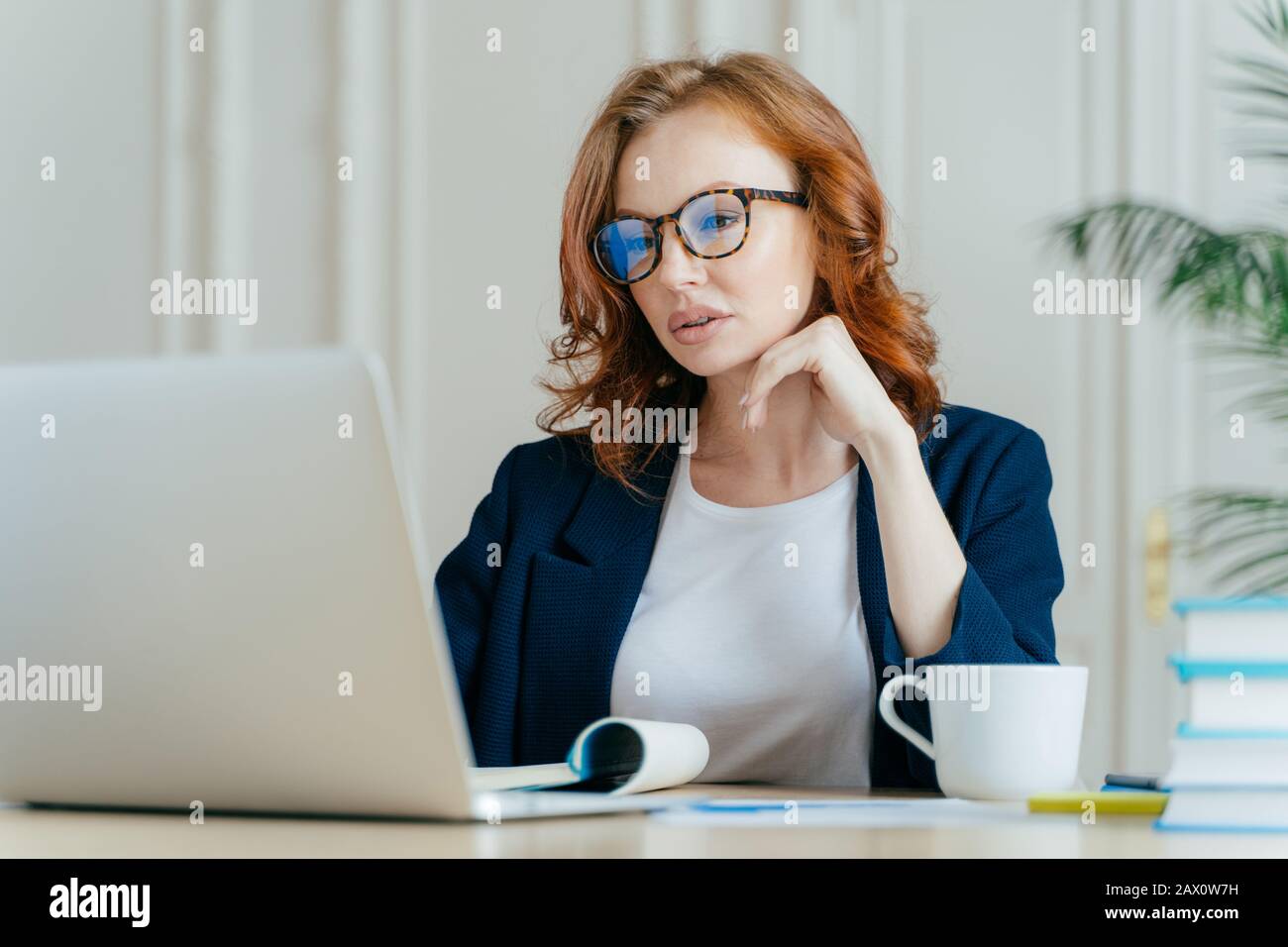 Shot of atttactive businesswoman concentrated in monitor of laptop ...
