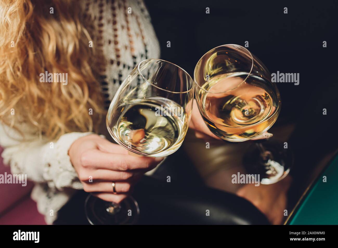 Clinking glasses with alcohol and toasting, party Stock Photo - Alamy