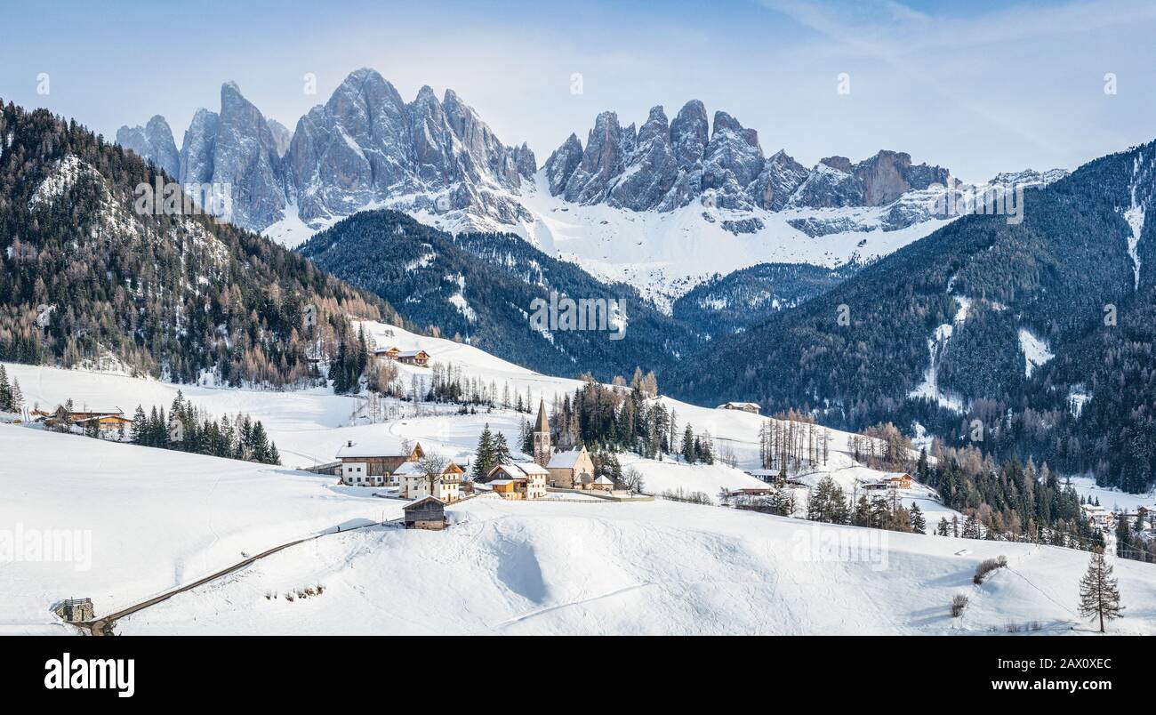 Classic view of famous Dolomites mountain peaks with the village Val di ...