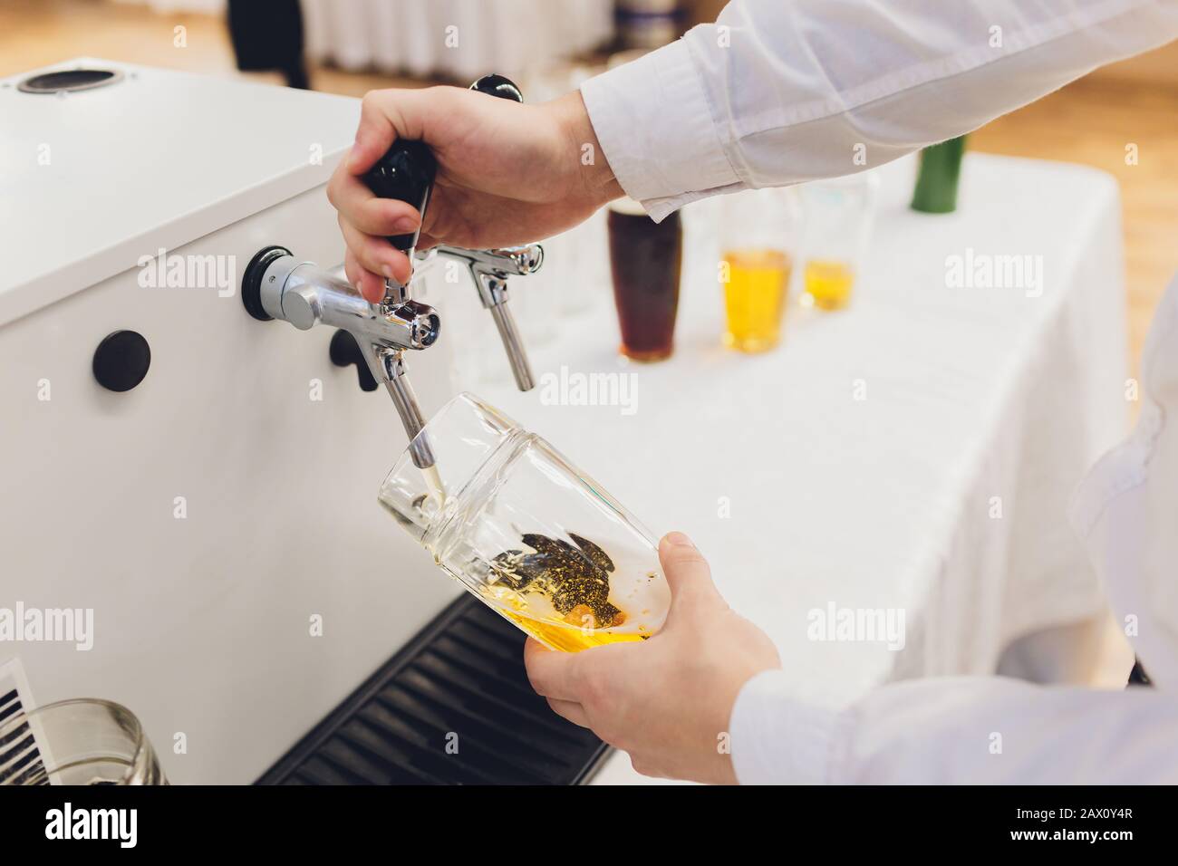 Bartender pouring draft beer in the bar Stock Photo - Alamy