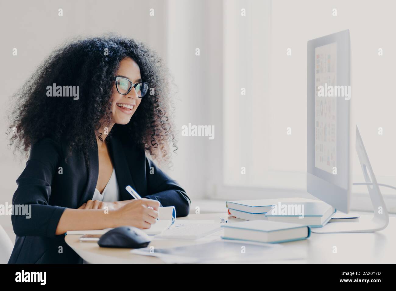 Professional curly haired woman manager makes report, focused into ...