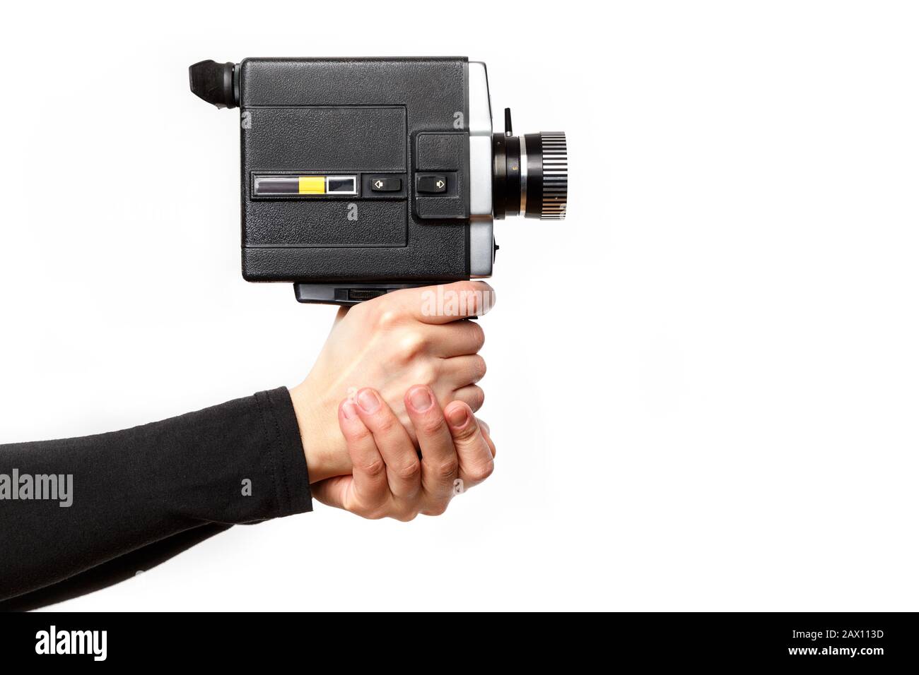 Female hand holding old style 8 mm movie camera isolated on a white ...