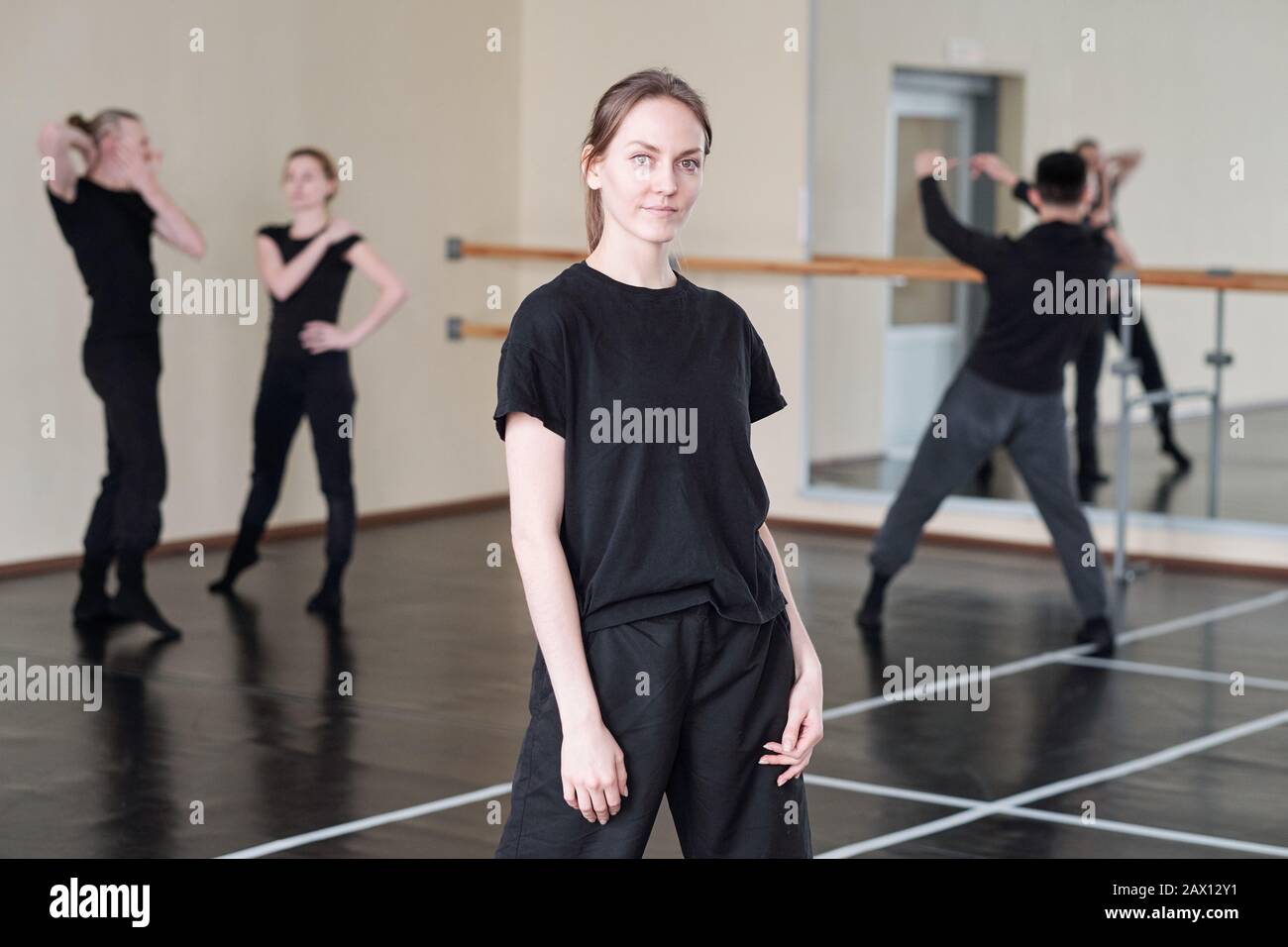 Horizontal medium long portrait of young woman wearing stylish black ...