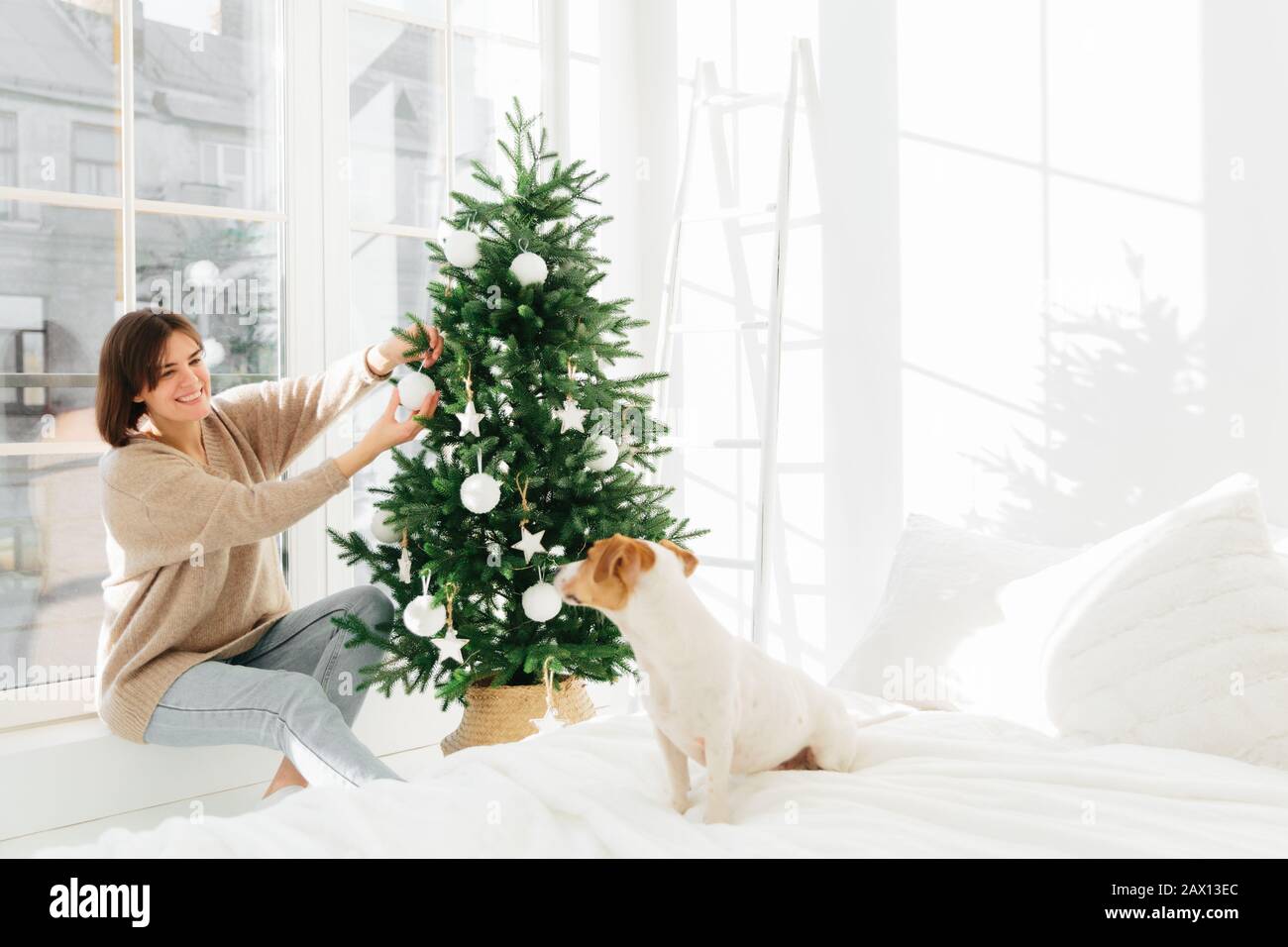 Woman dresses christmas tree hi-res stock photography and images - Alamy