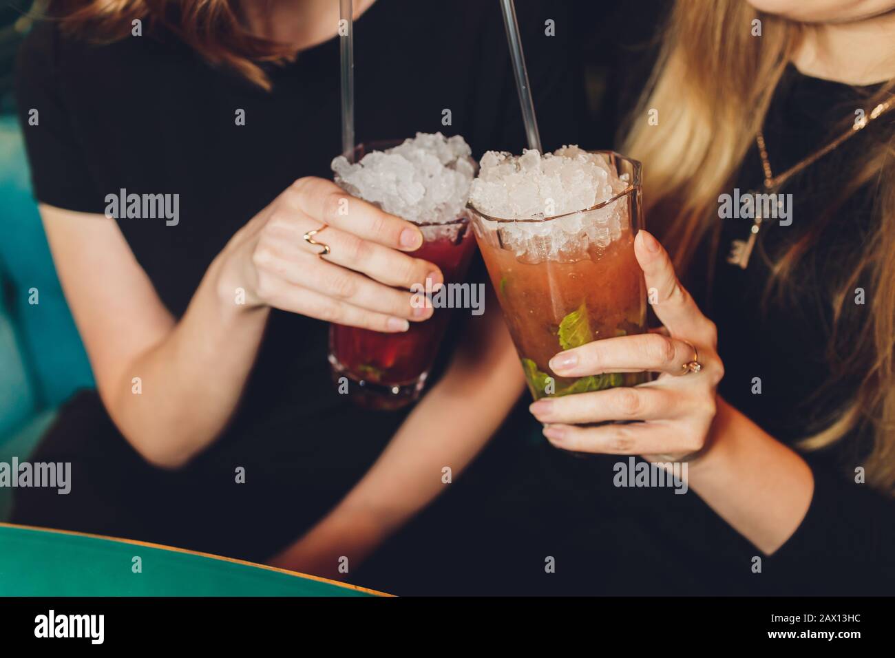 Clinking glasses with alcohol and toasting, party Stock Photo - Alamy