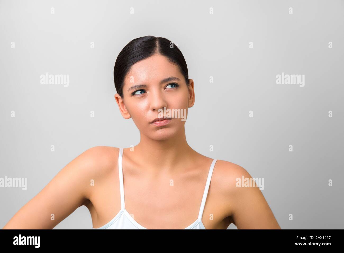 am i beautiful. beauty woman thinking and looking up isolated on grey ...