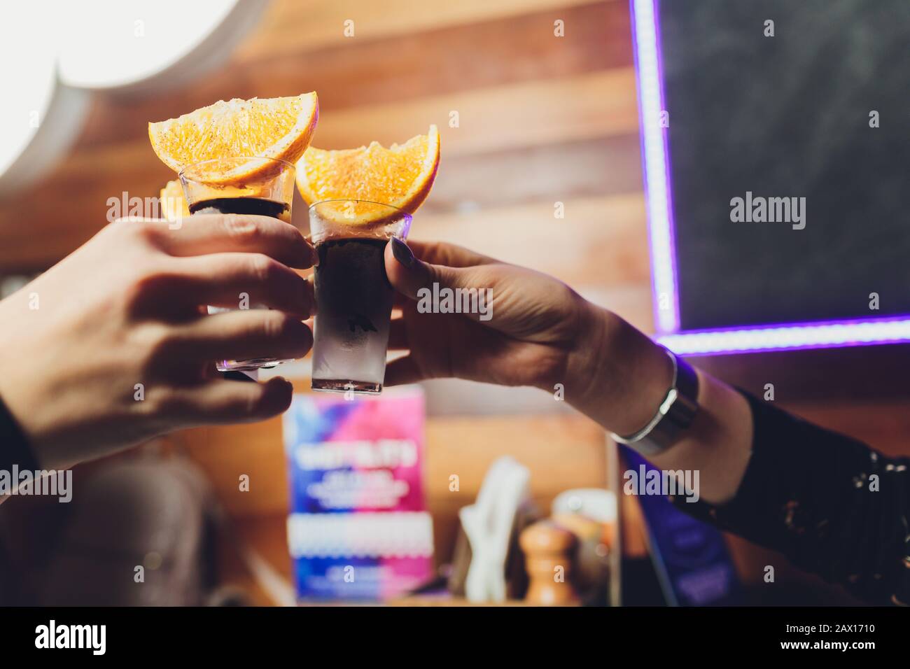 Clinking glasses with alcohol and toasting, party Stock Photo - Alamy
