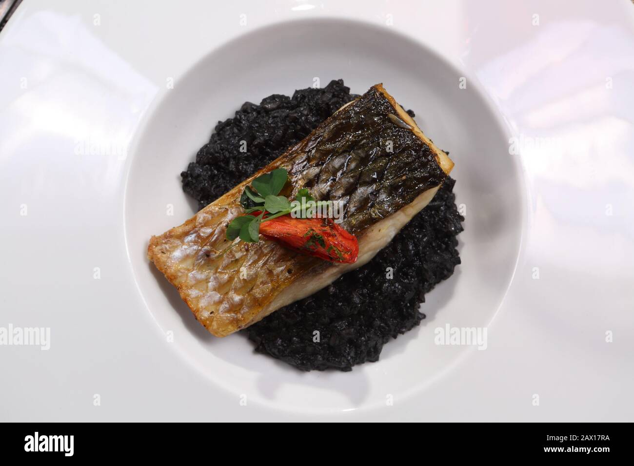 Dorado fillet with vegetables on a white background Stock Photo - Alamy