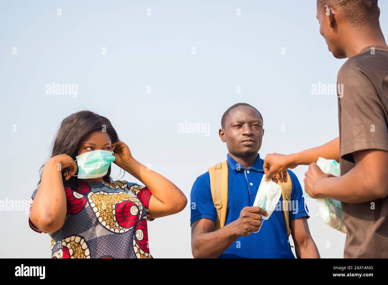 Handing out masks hi-res stock photography and images - Alamy