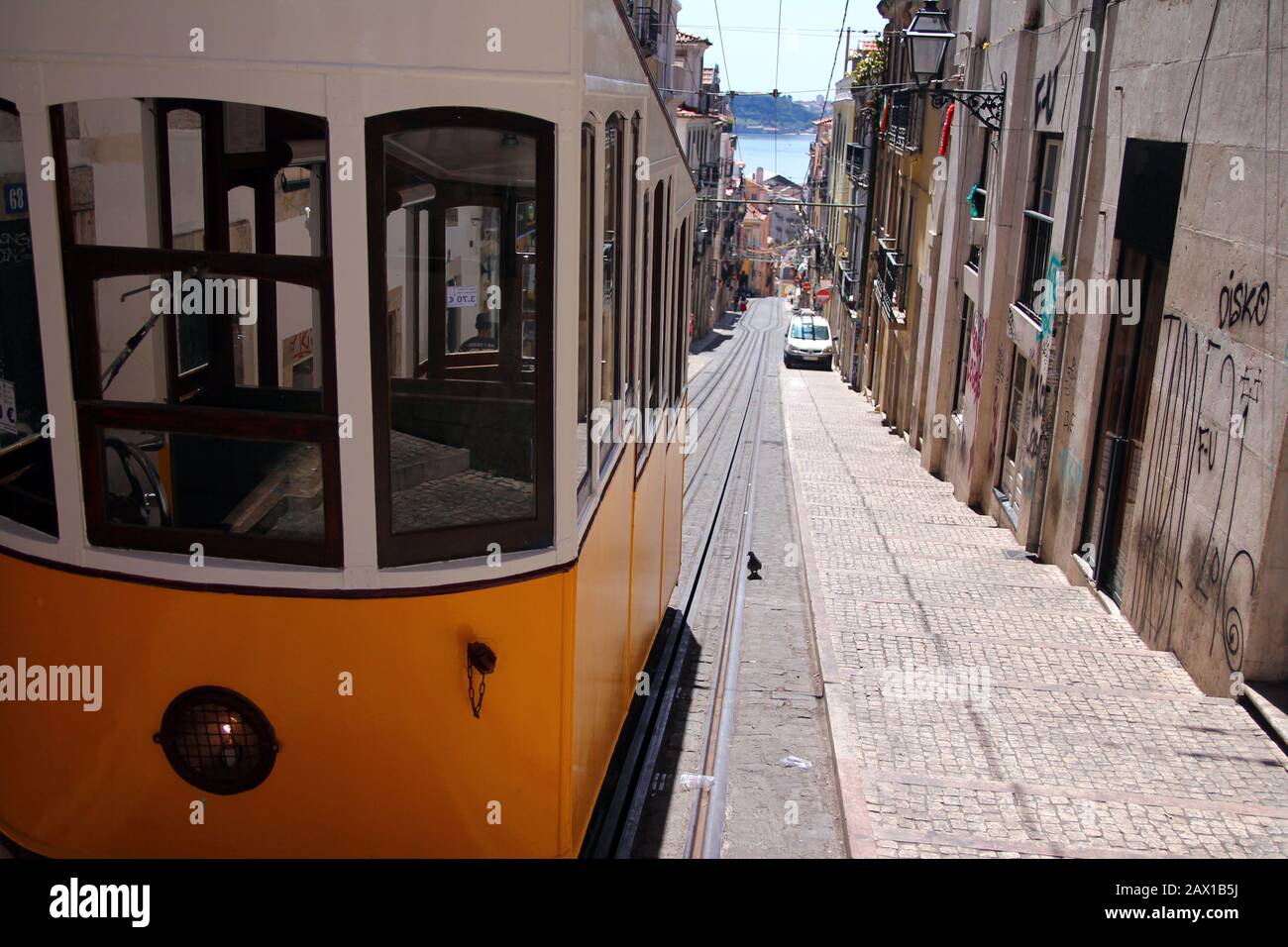 Typical yellow cable car in Lisbon Stock Photo - Alamy