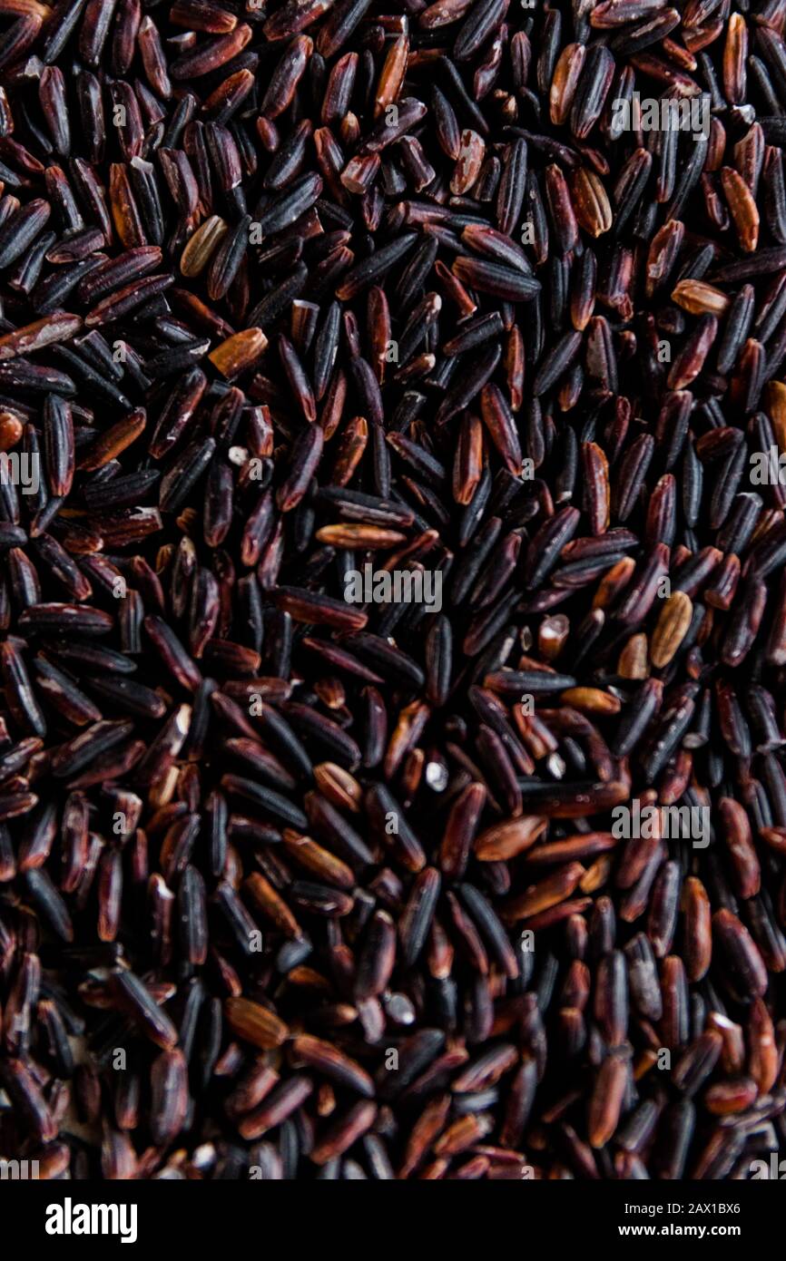 Black wild rice close-up background texture top view, selective focus ...