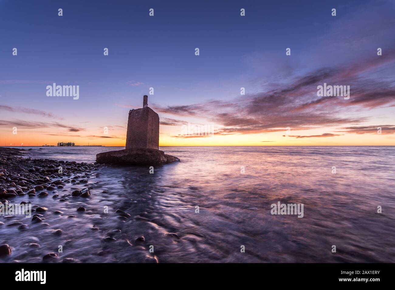 Pylon in the sea in a beautiful sunrise Stock Photo - Alamy