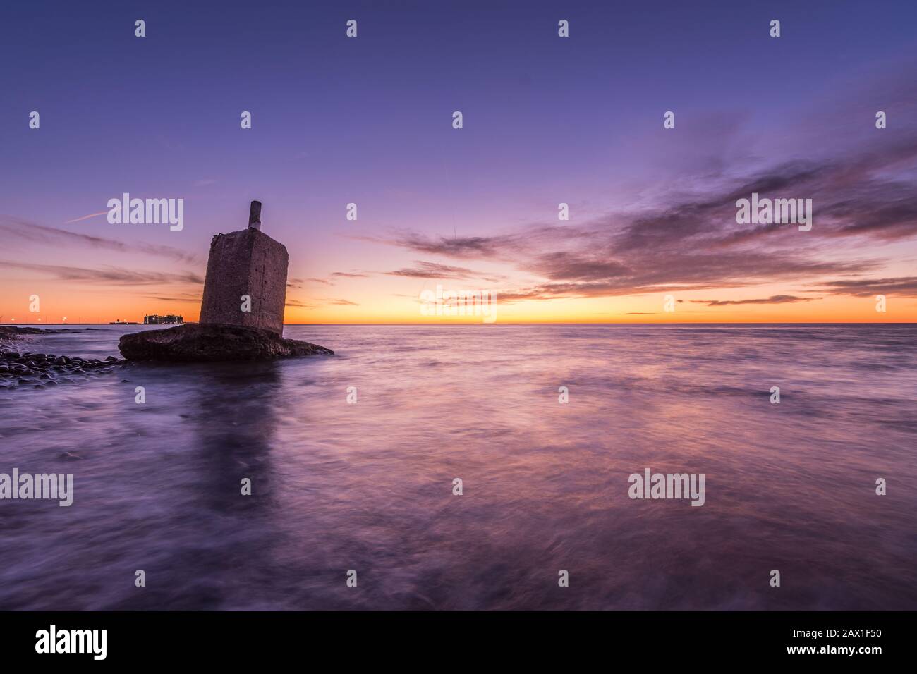 Pylon in the sea in a beautiful sunrise Stock Photo - Alamy