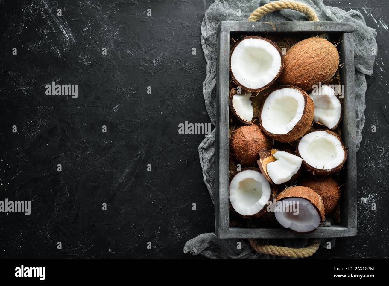Coconut in a wooden box. Tropical Fruits. Nut. Top view. Free space for ...