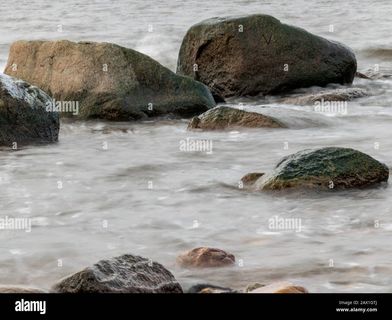landscape with stony beach, stones of various shapes in the sea Stock ...