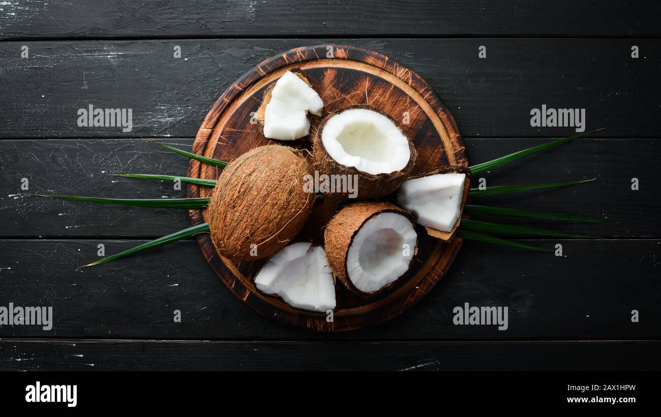 Fresh coconut on a black background. Tropical Fruits. Nut. Top view ...