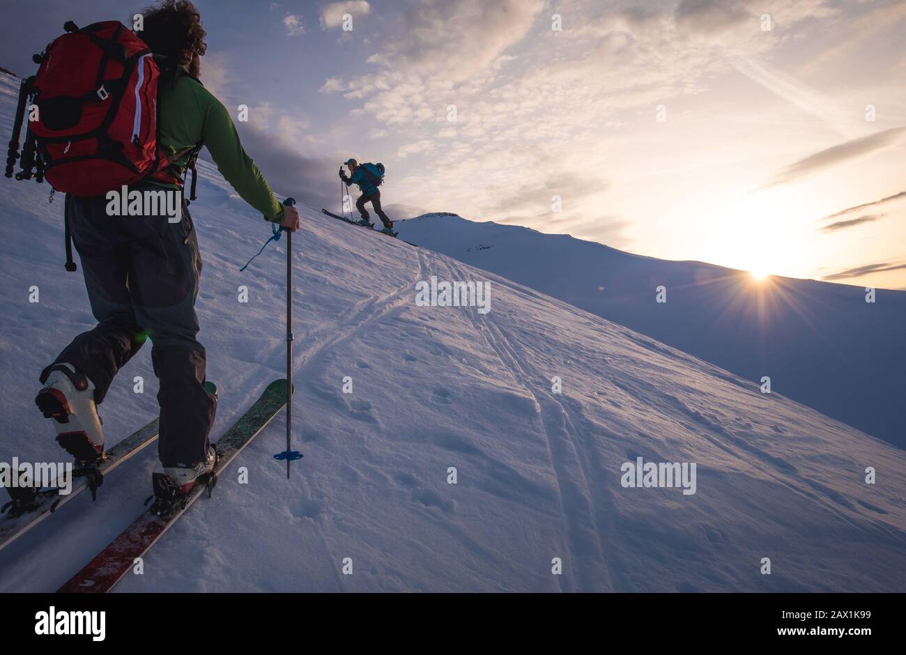 Two people backcountry skiing in Iceland at sunrise Stock Photo - Alamy