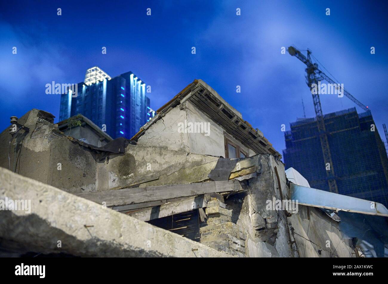 Old ruined house in front of modern buildings in construction Stock ...