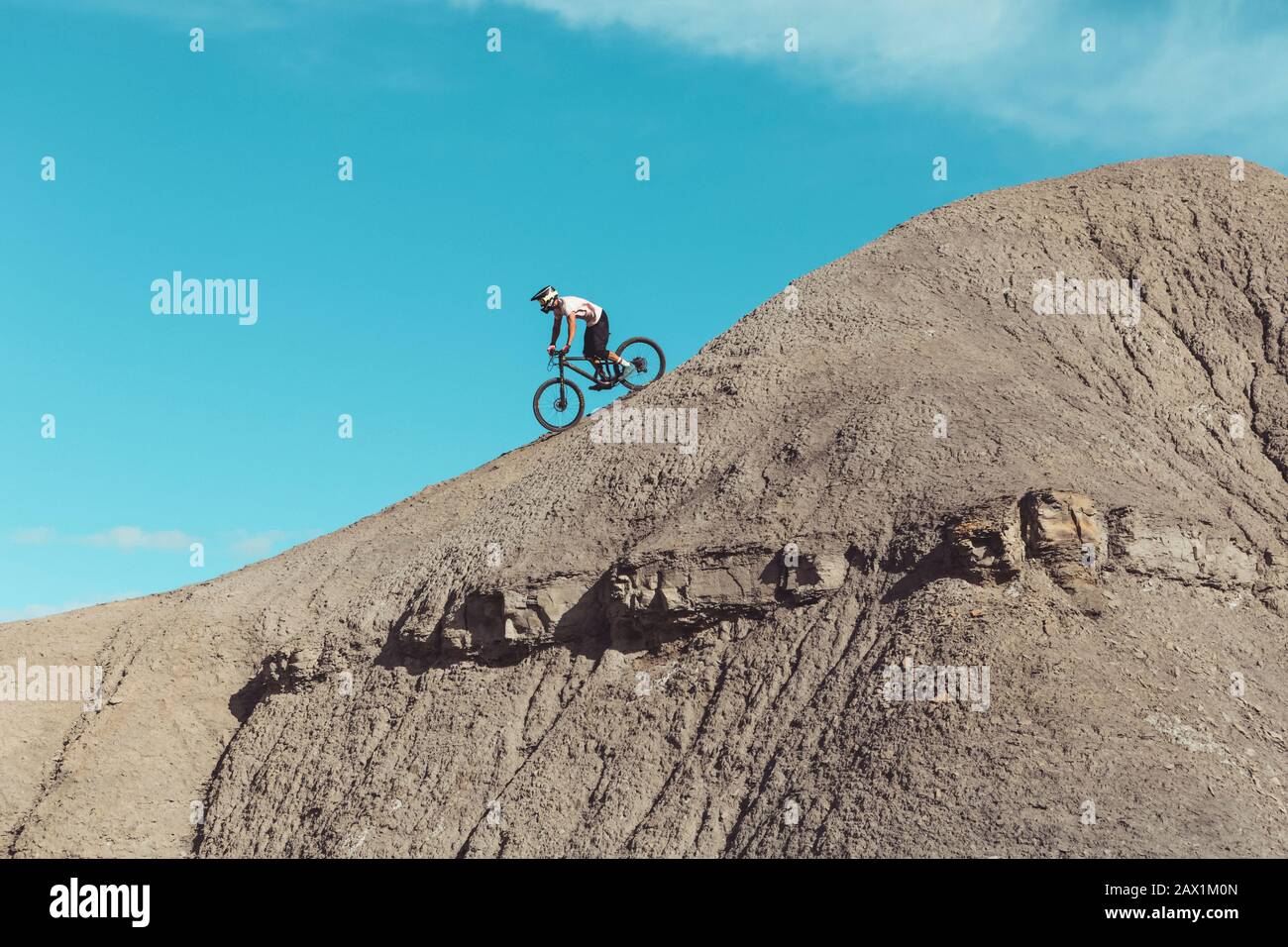Side view of Mountainbiker riding steep desert terrain Stock Photo - Alamy