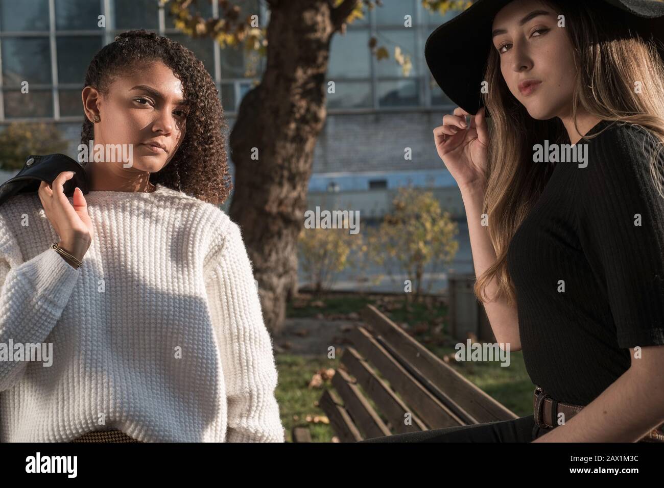 pair of young beautiful mexican generation girls. The girl is sitting ...