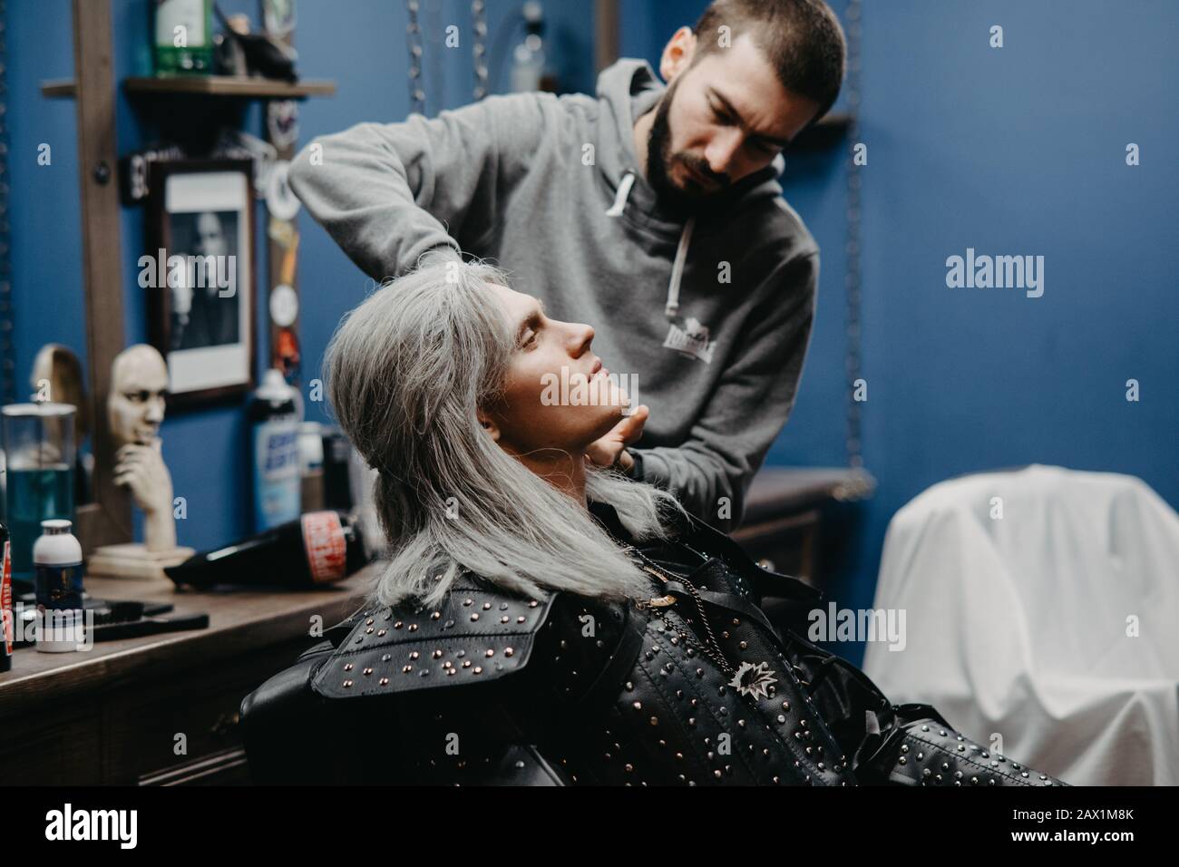 Cosplayer in image of ancient warrior witcher makes hair styling at ...