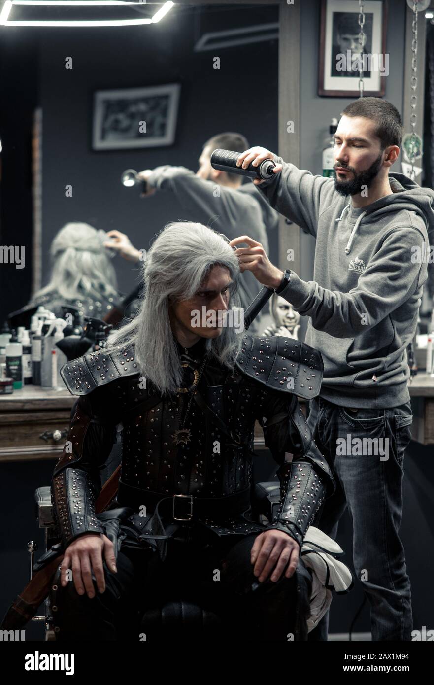 Cosplayer in image of ancient warrior witcher makes hair styling at ...