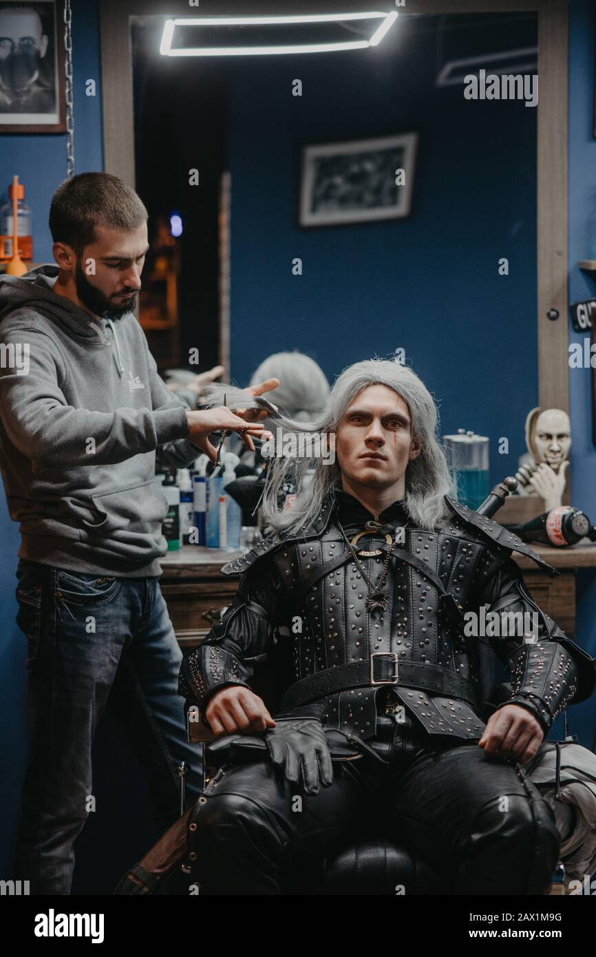 Cosplayer in image of ancient warrior witcher makes hair styling at ...