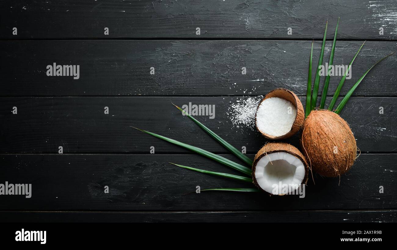 Fresh coconut on a black background. Tropical Fruits. Nut. Top view ...