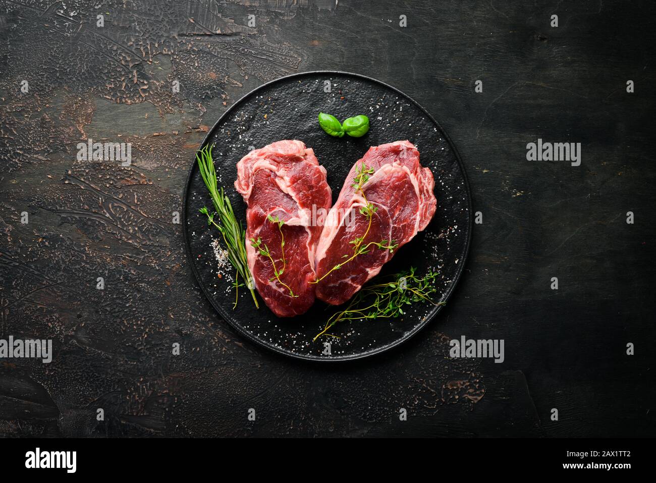 Raw marbled meat Black Angus Steak Ribeye. At the aged table. Top view ...