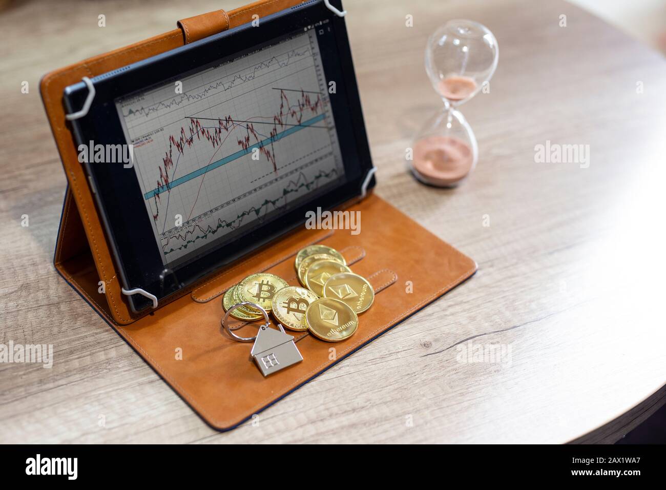 Crypto currency bitcoin on table with tablet and hourglass Stock Photo ...
